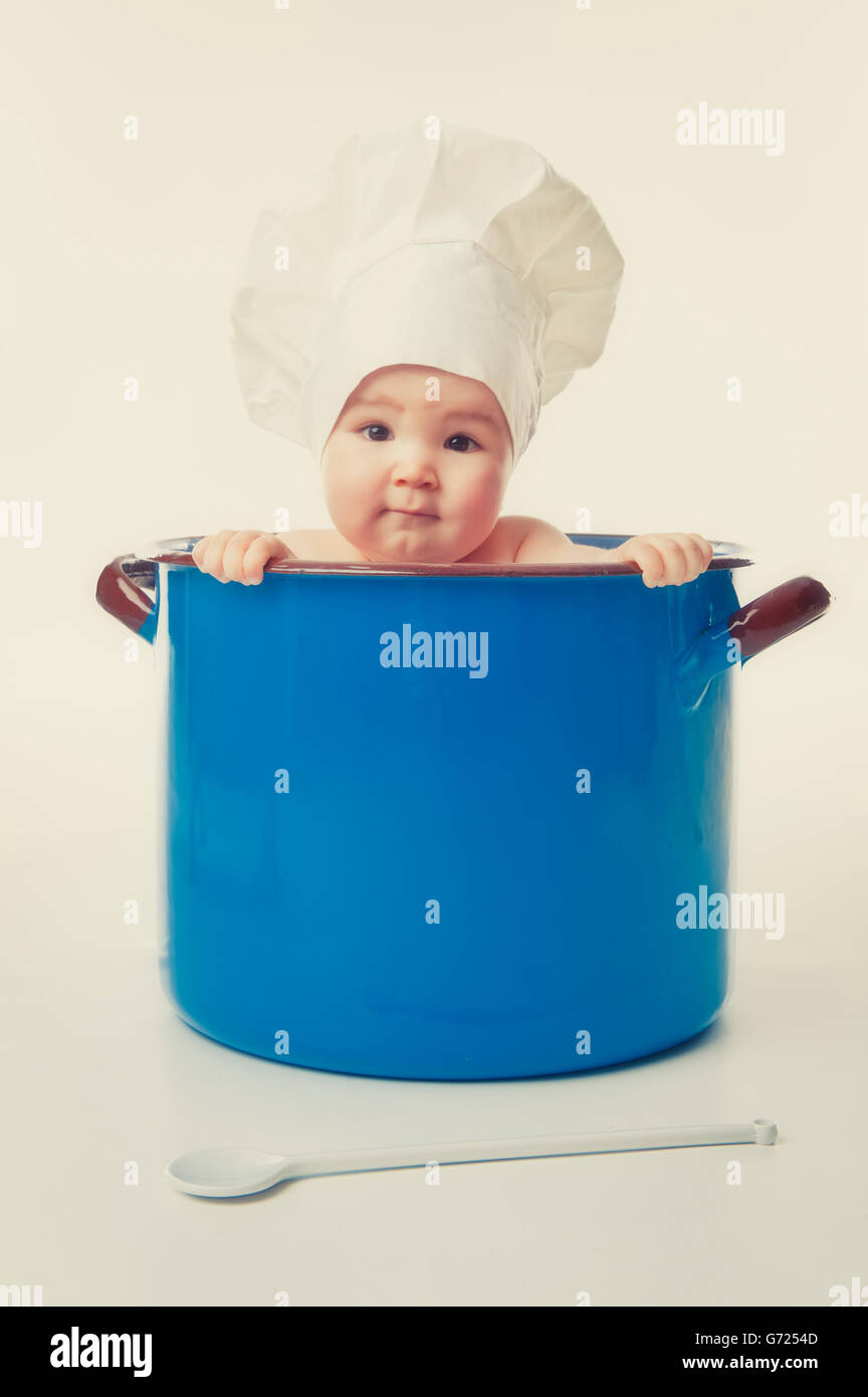 Little child wearing chef's hat, in a cooking pot Stock Photo - Alamy