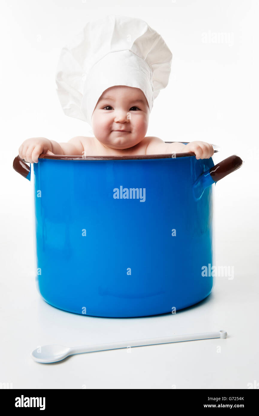Little child wearing chef's hat, in a cooking pot Stock Photo - Alamy