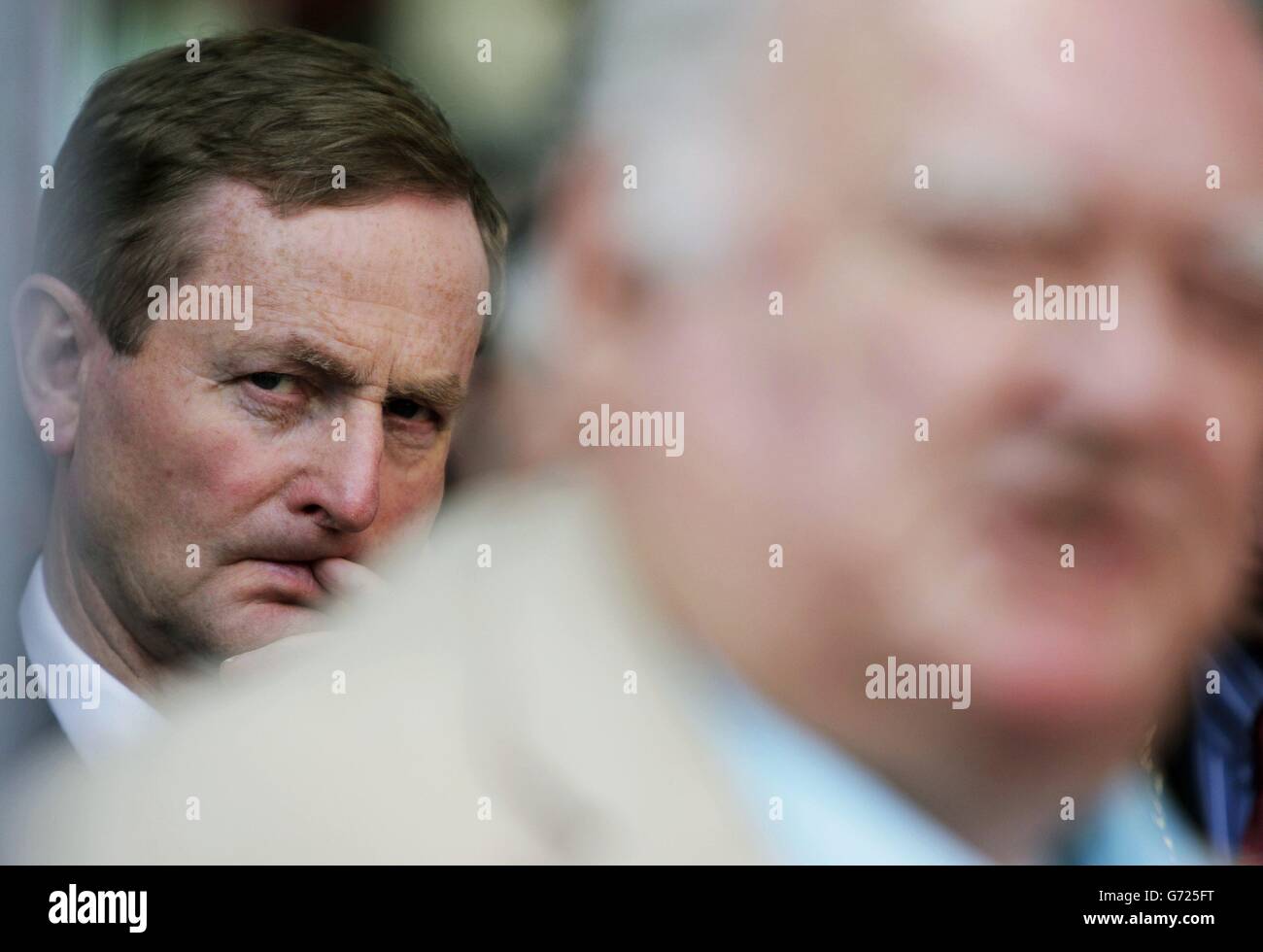 An Taoiseach Enda Kenny listens as author and historian Tim Pat Coogan ...
