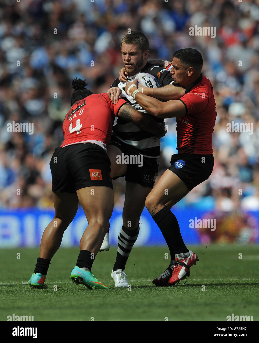 Widnes Vikings' Rhys Hanbury is tackled by Salford Red Devils' Junior ...