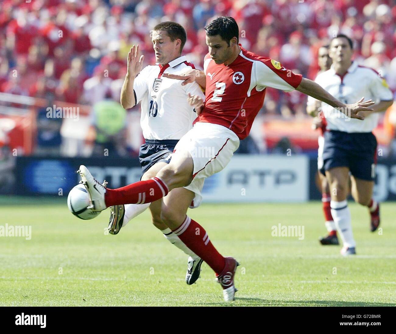England's Michael Owen (left) battles with Switzerland's Bernt Haas for ...