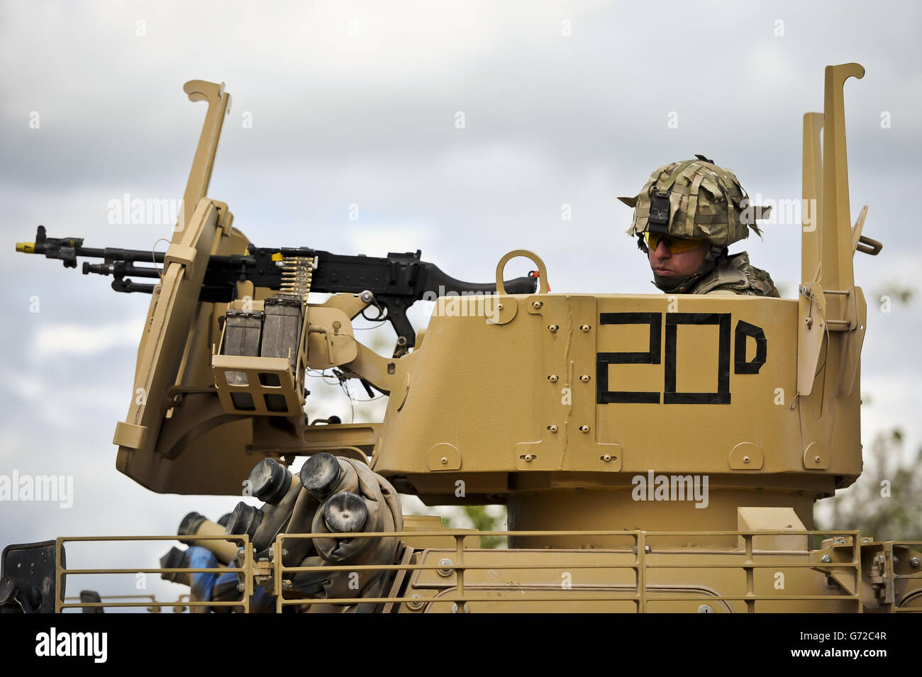 A soldier from 5 Rifles looks out of the top of a warthog vehicle as ...
