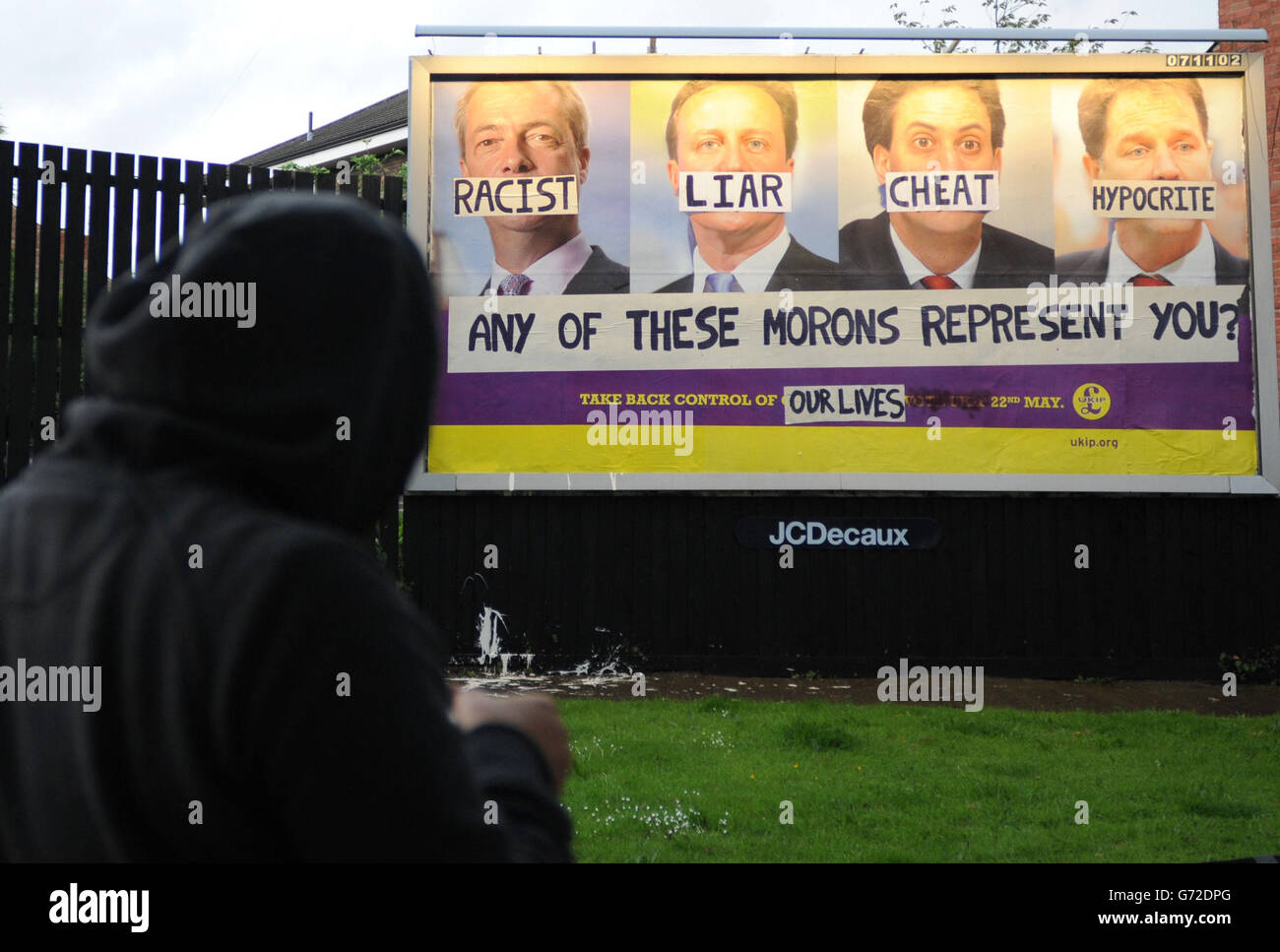 A man looks at a vandalised UKIP Euro and Local Elections billboard in ...