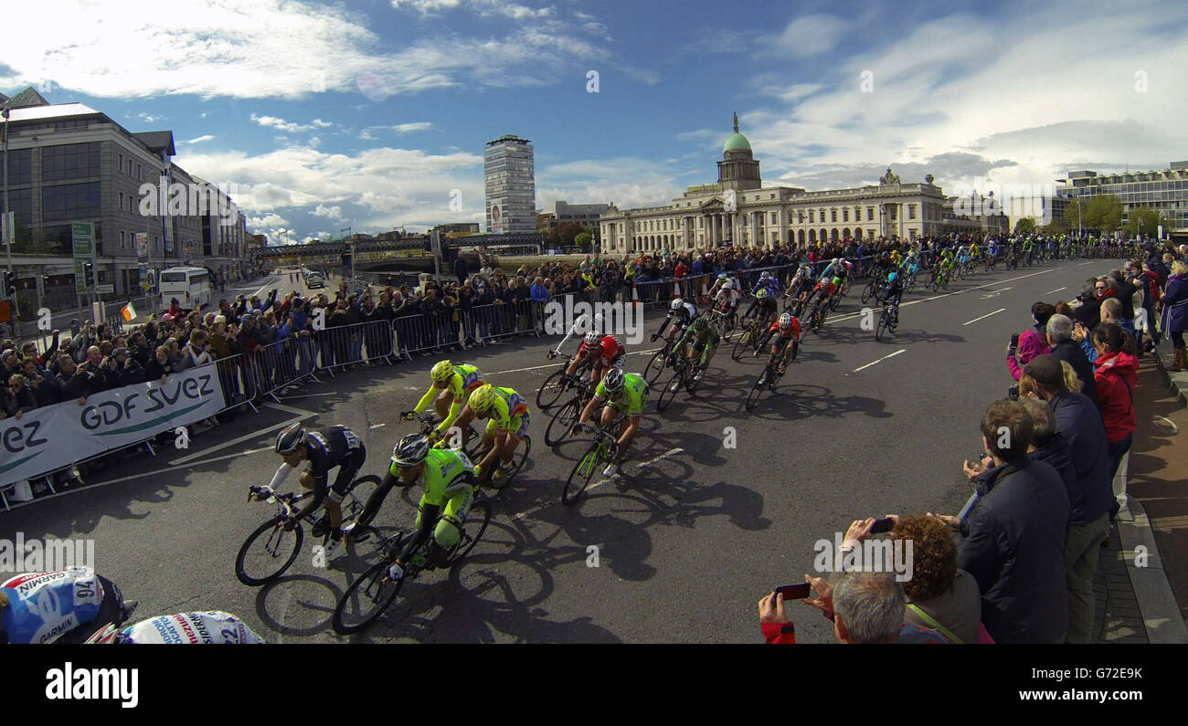 The Peloton travels across Matt Talbot Bridge past the Customs house ...