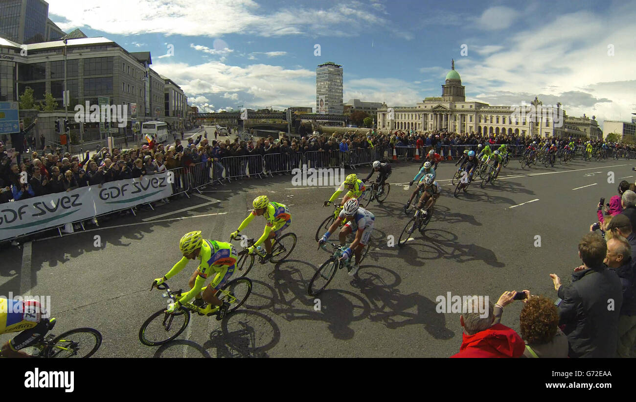 The Peloton travels across Matt Talbot Bridge past the Customs house ...