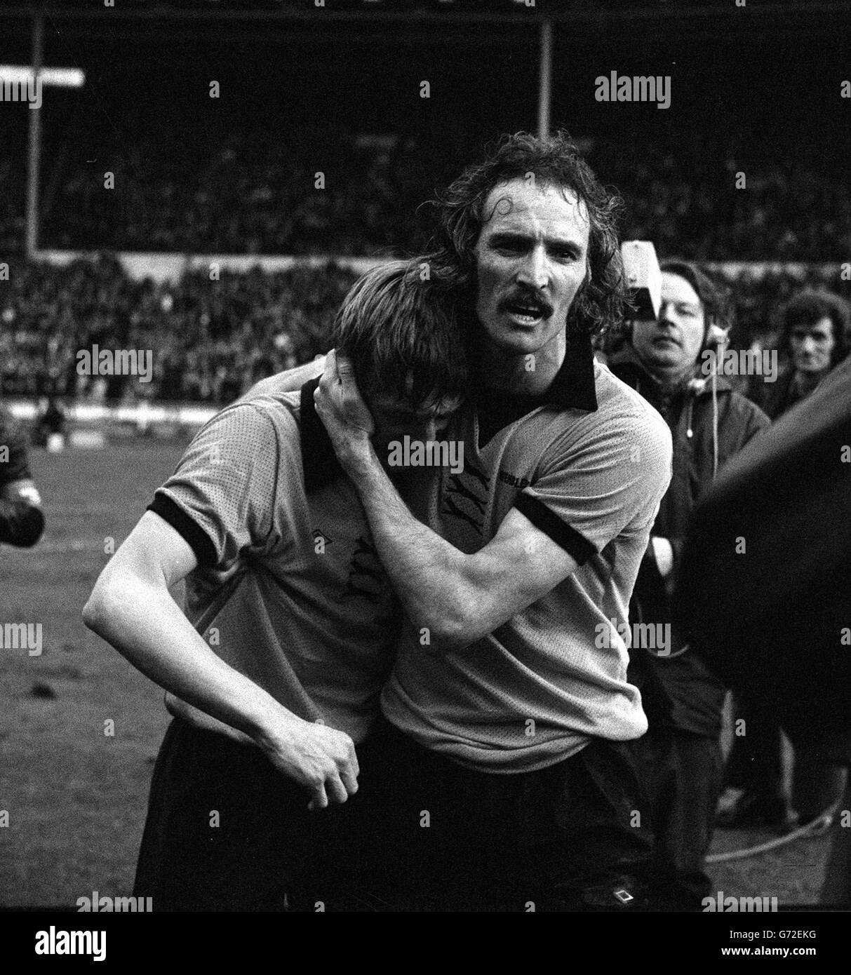 Wolverhampton Wanderers striker Derek Dougan (right) hugs team mate ...