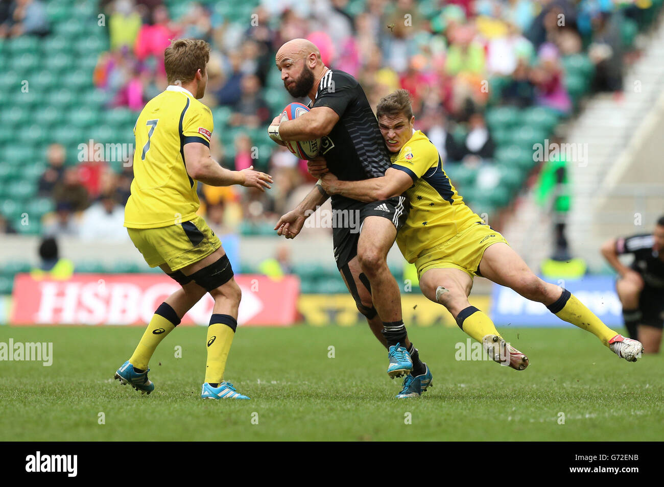 New Zealand's Captain D J Forbes is tackled by Australia's Cameron ...