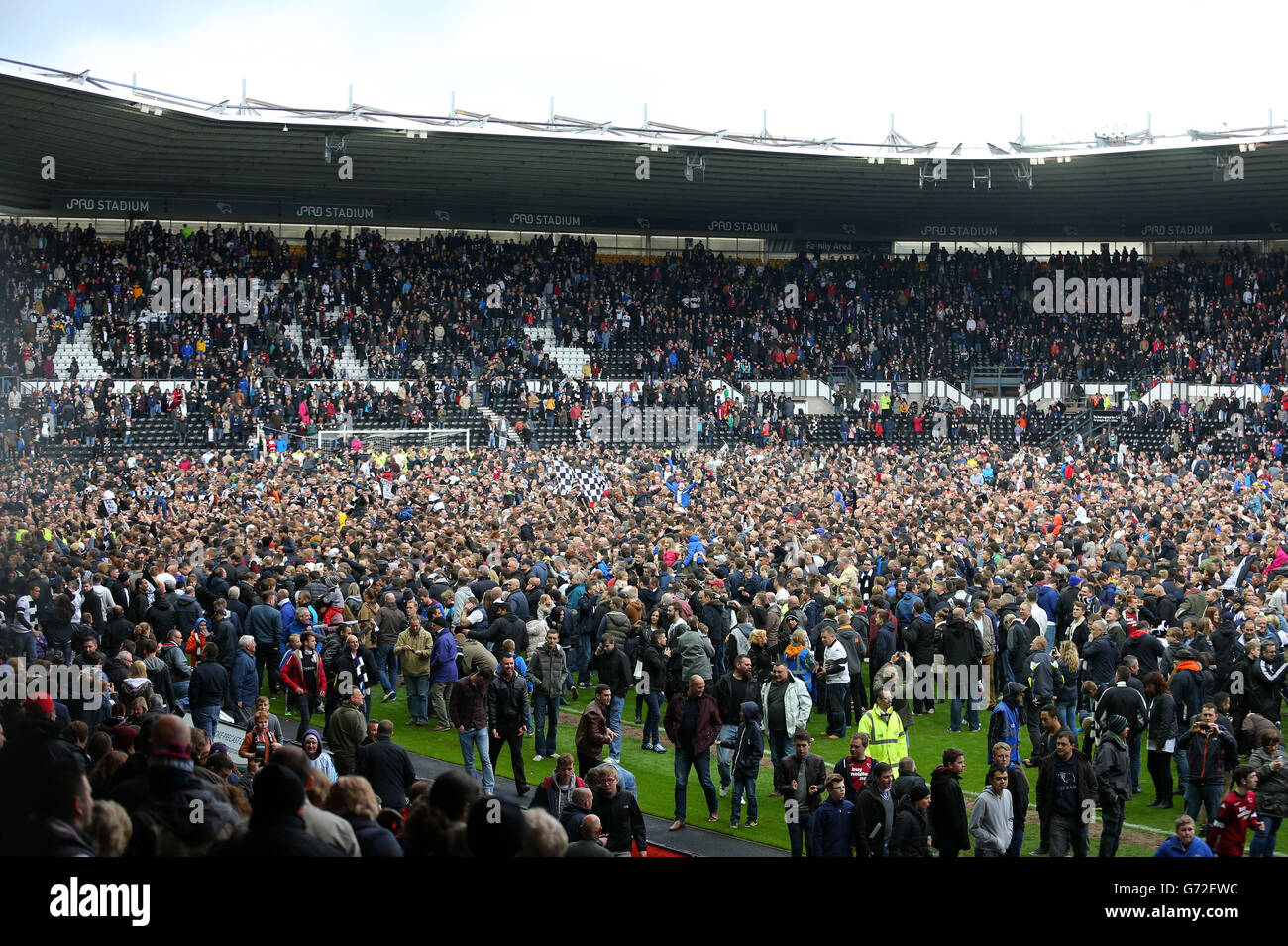 Derby County fans celebrate on the pitch after beating Brighton to ...