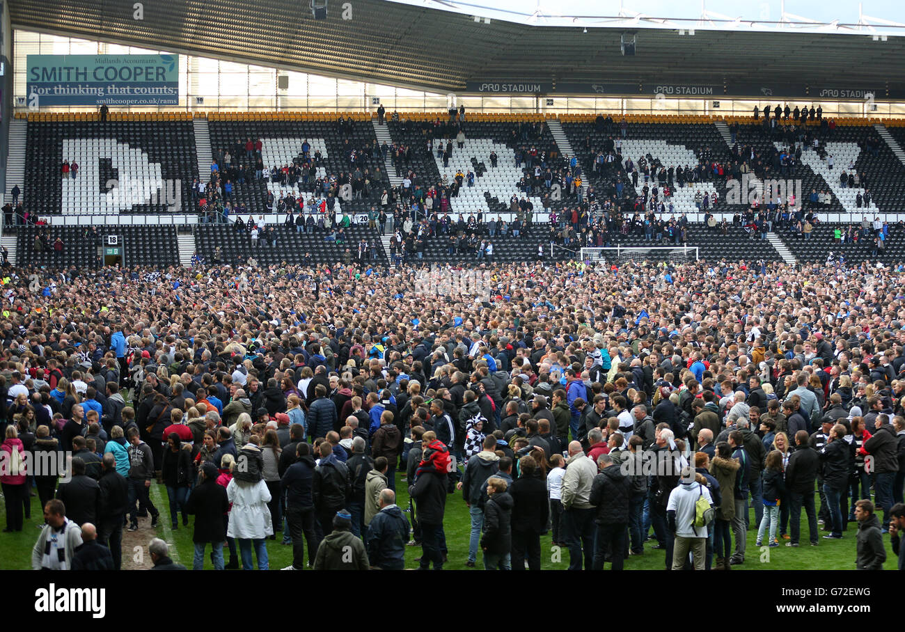 Derby County fans celebrate on the pitch after beating Brighton to ...