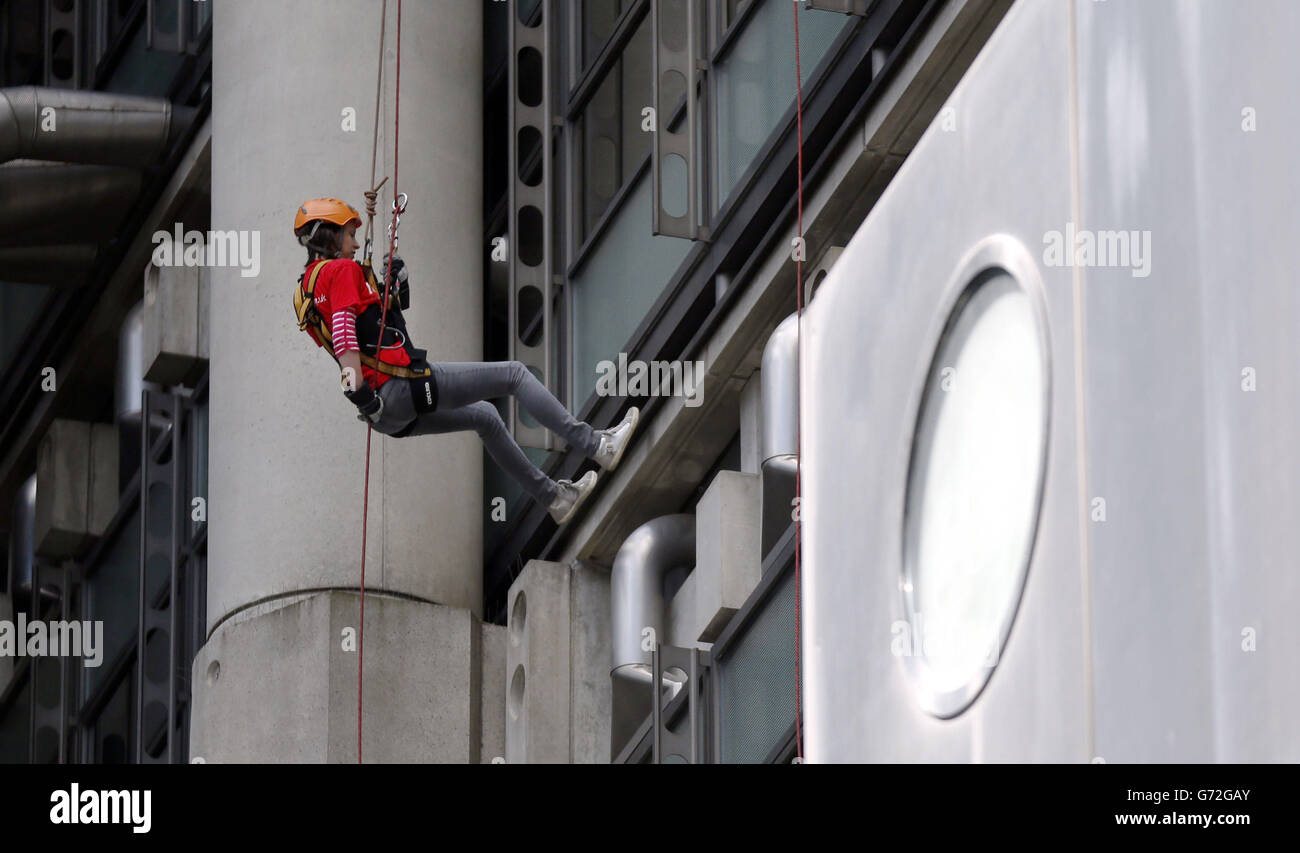 Fundraisers employed in the City of London abseil down the Lloyds of ...