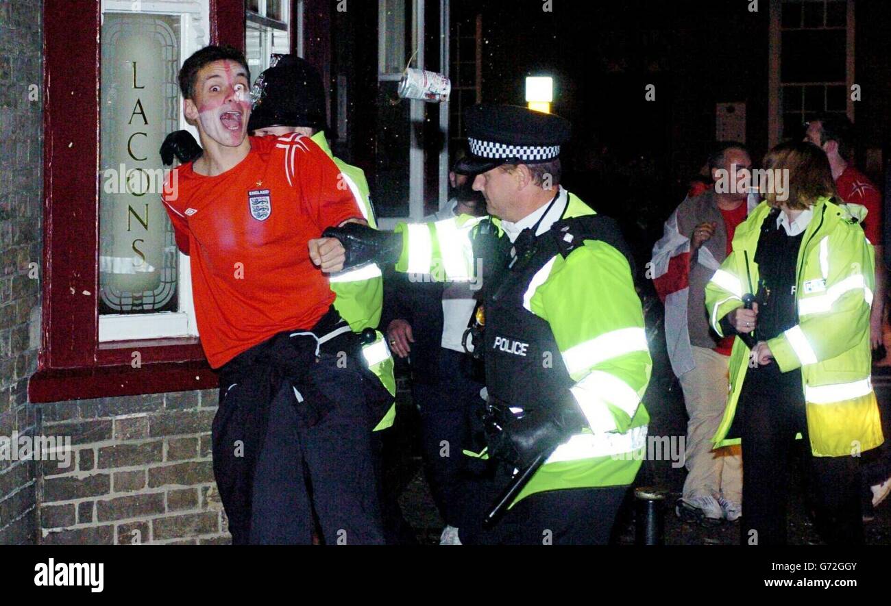 A man is led away after disturbance Stock Photo - Alamy