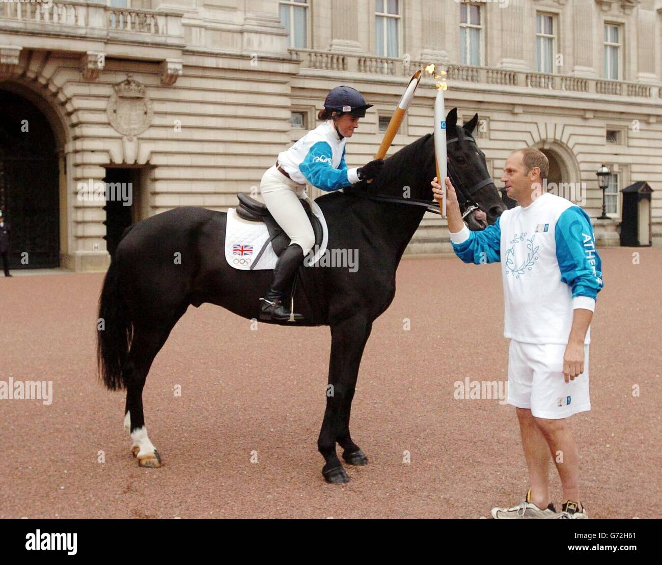 Pippa Funnell on horseback, hands over the Olympic flame to Sir Steve ...