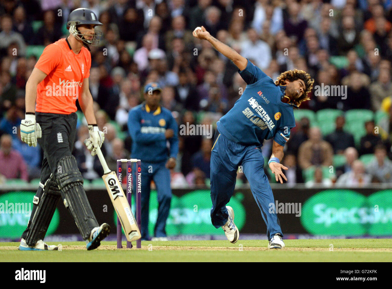England's Alex Hales (left) walks-in as Sri Lanka's Lasith Malinga ...