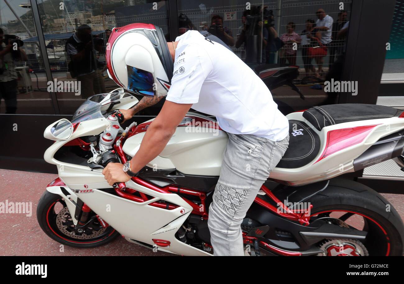 Great Britain's Lewis Hamilton arrives on a motor bike in the paddock at the Circuit de Monaco ...