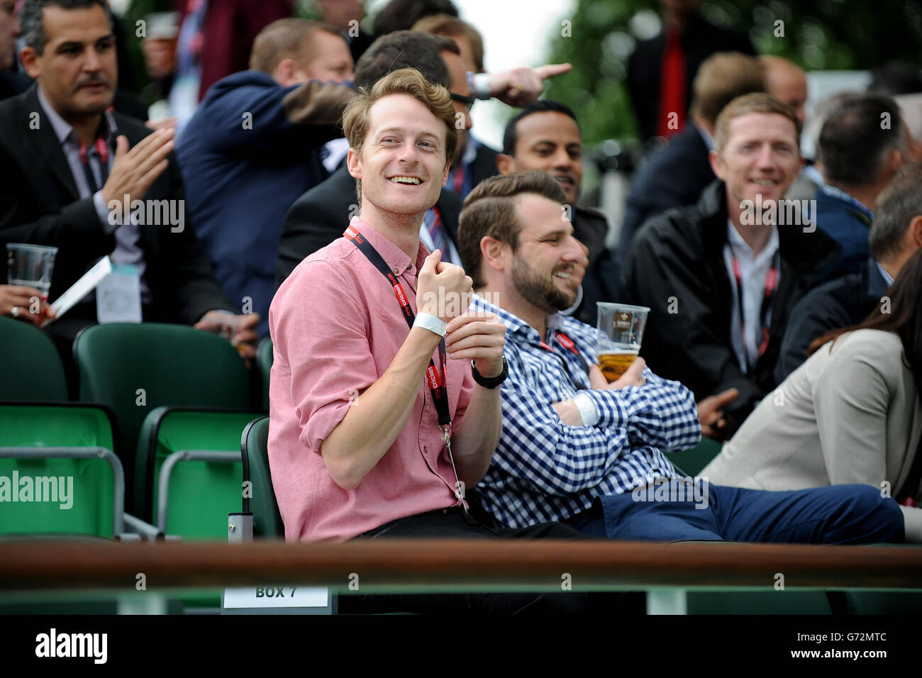 Spectators have a drink and a laugh whilst enjoying the cricket Stock ...
