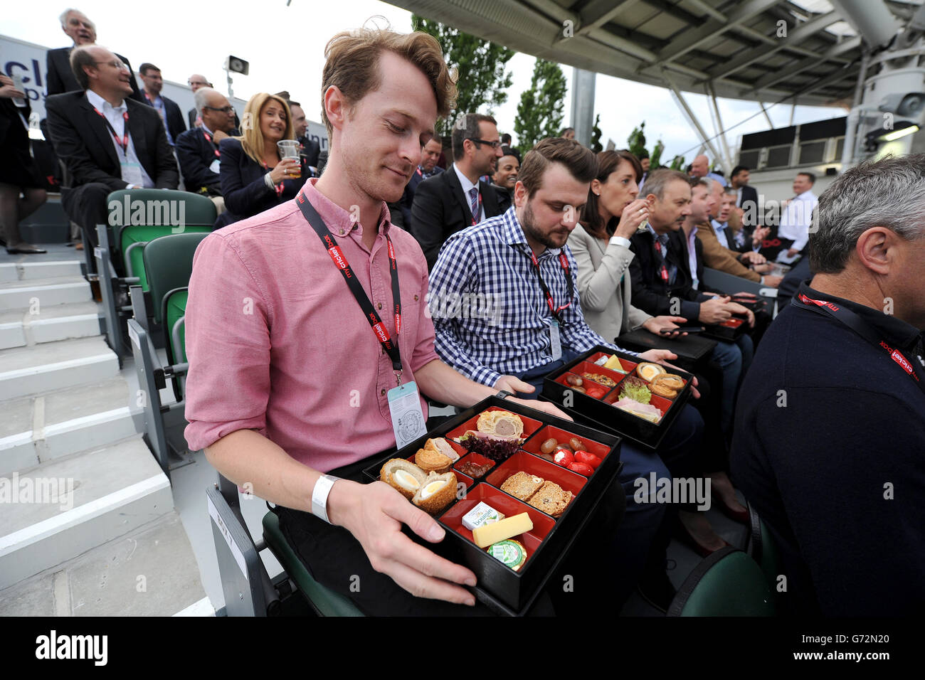 Spectators enjoy lunch whilst watching the cricket from the stands hi ...