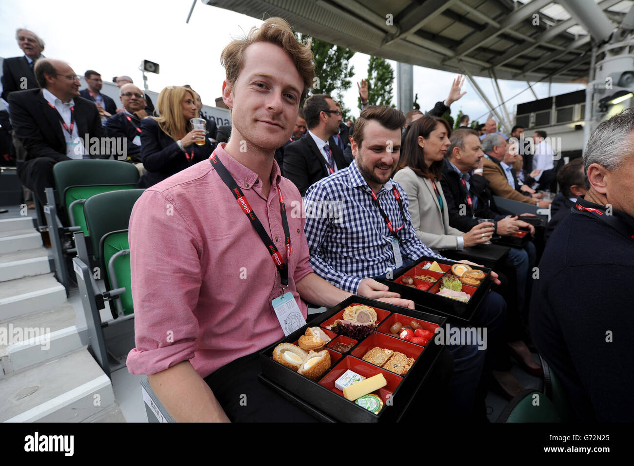 Spectators enjoy lunch whilst watching the cricket from the stands hi ...