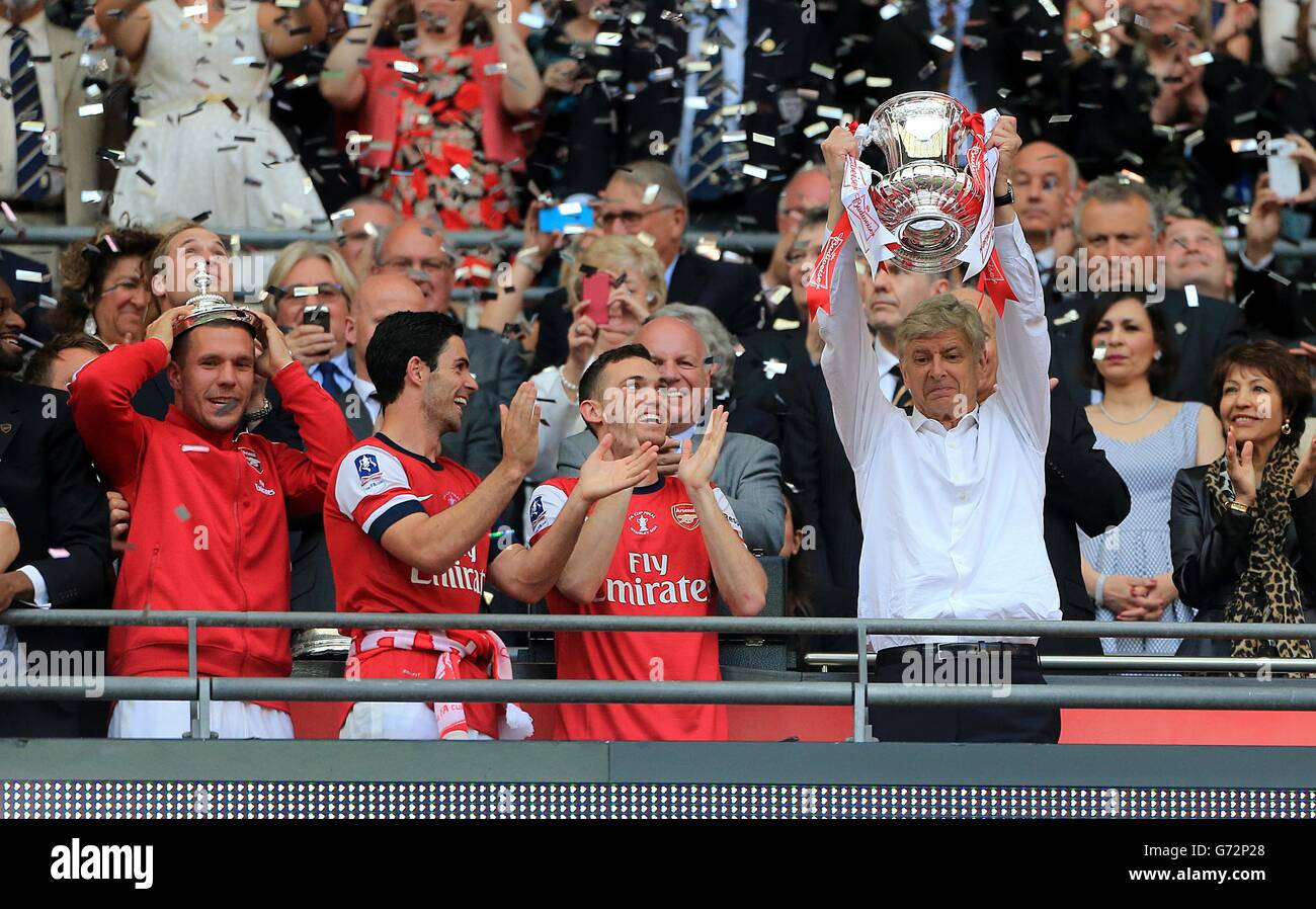 Arsenal manager Arsene Wenger celebrates with the FA Cup trophy in the ...