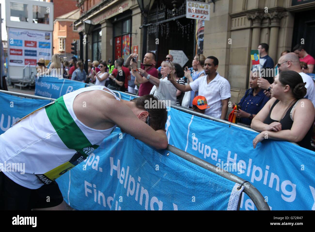 Runners react after the bupa great manchester run hi-res stock ...