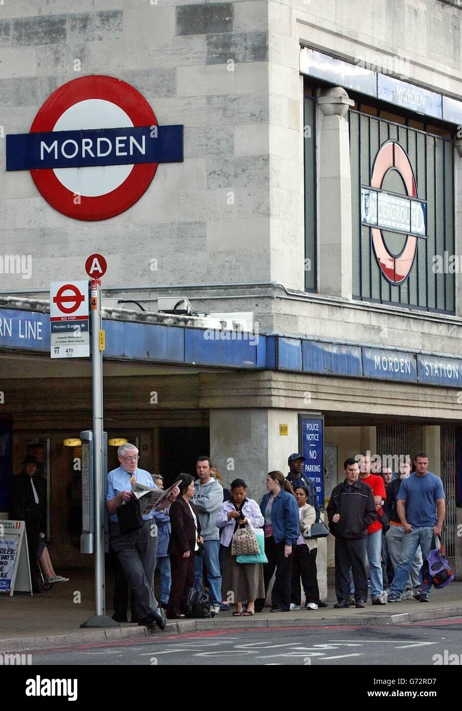 Commuters queue for a bus outside Morden station, as a 24 hour strike ...
