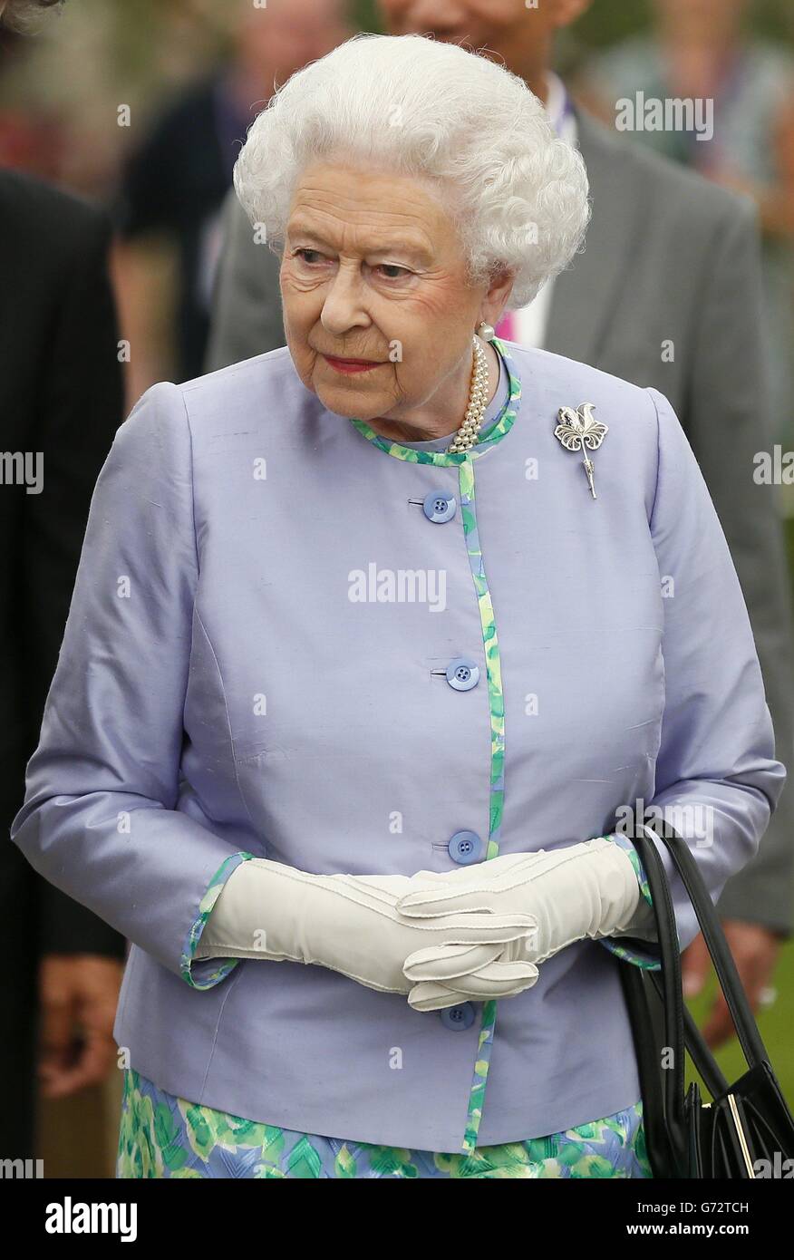 Queen Elizabeth II looks at a display during a visit to the Chelsea ...