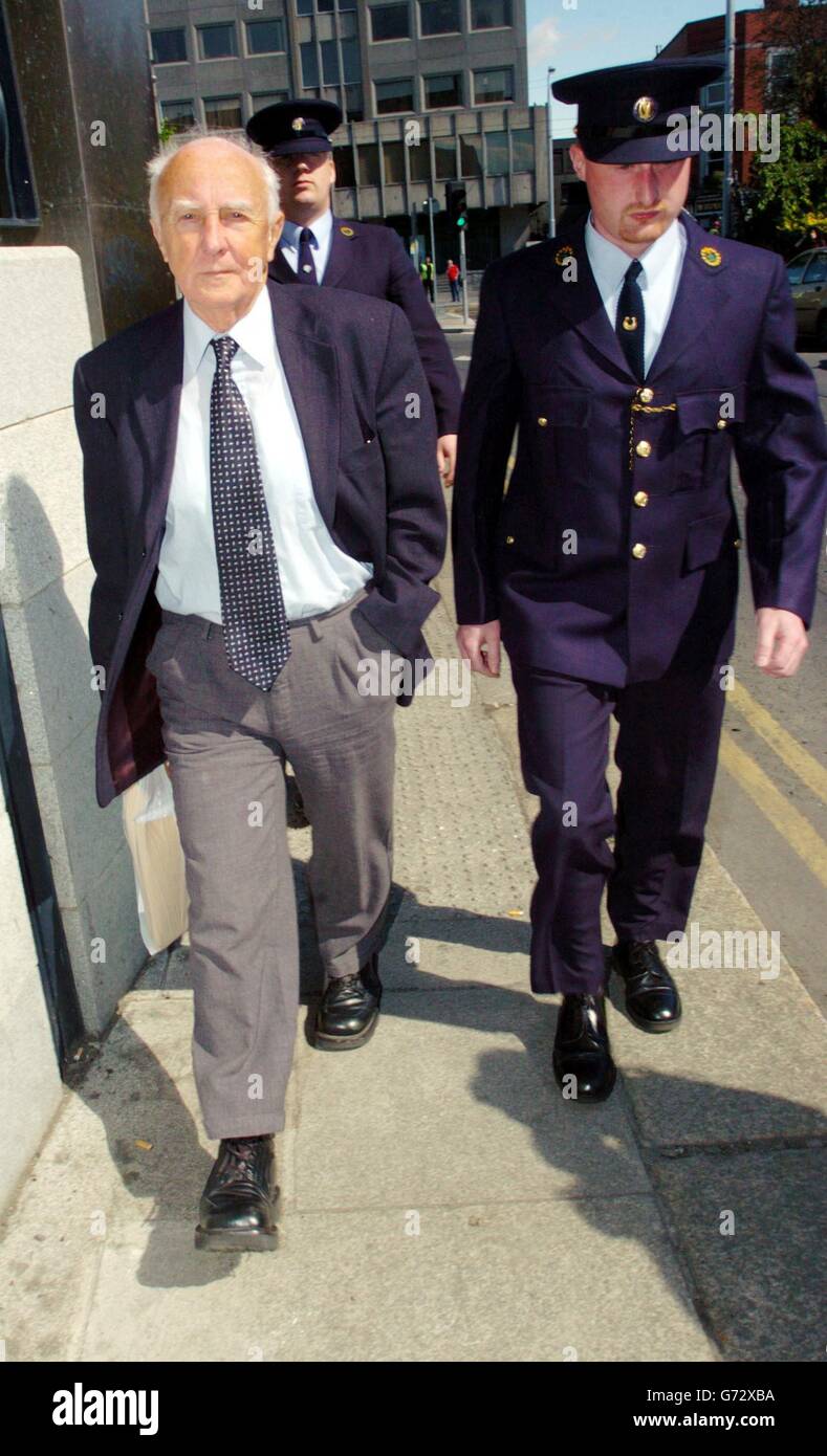 Former civil servant, George Redmond, being led into the Four Courts ...