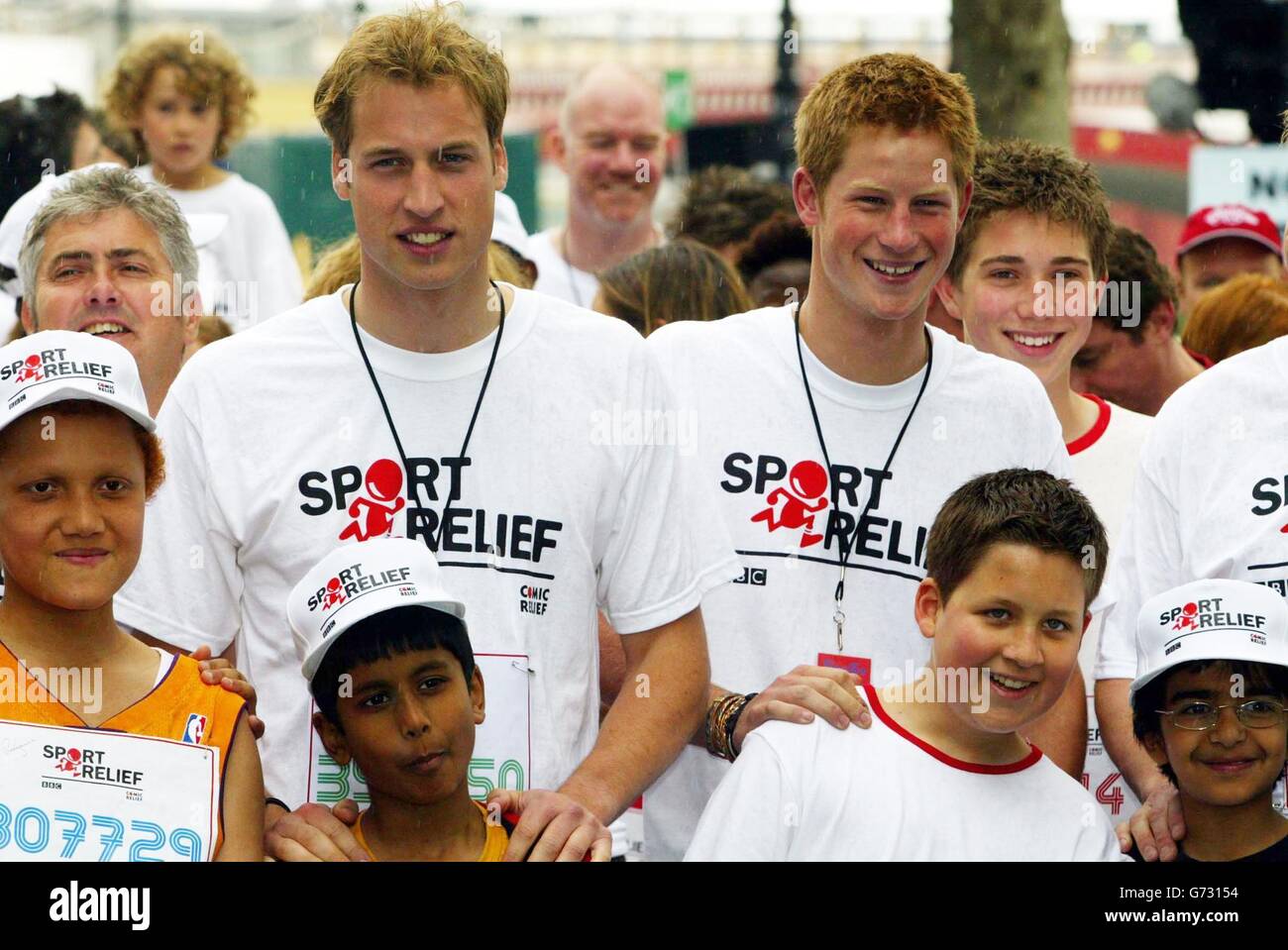 Prince William (left) and Prince Harry pose with children take part in ...
