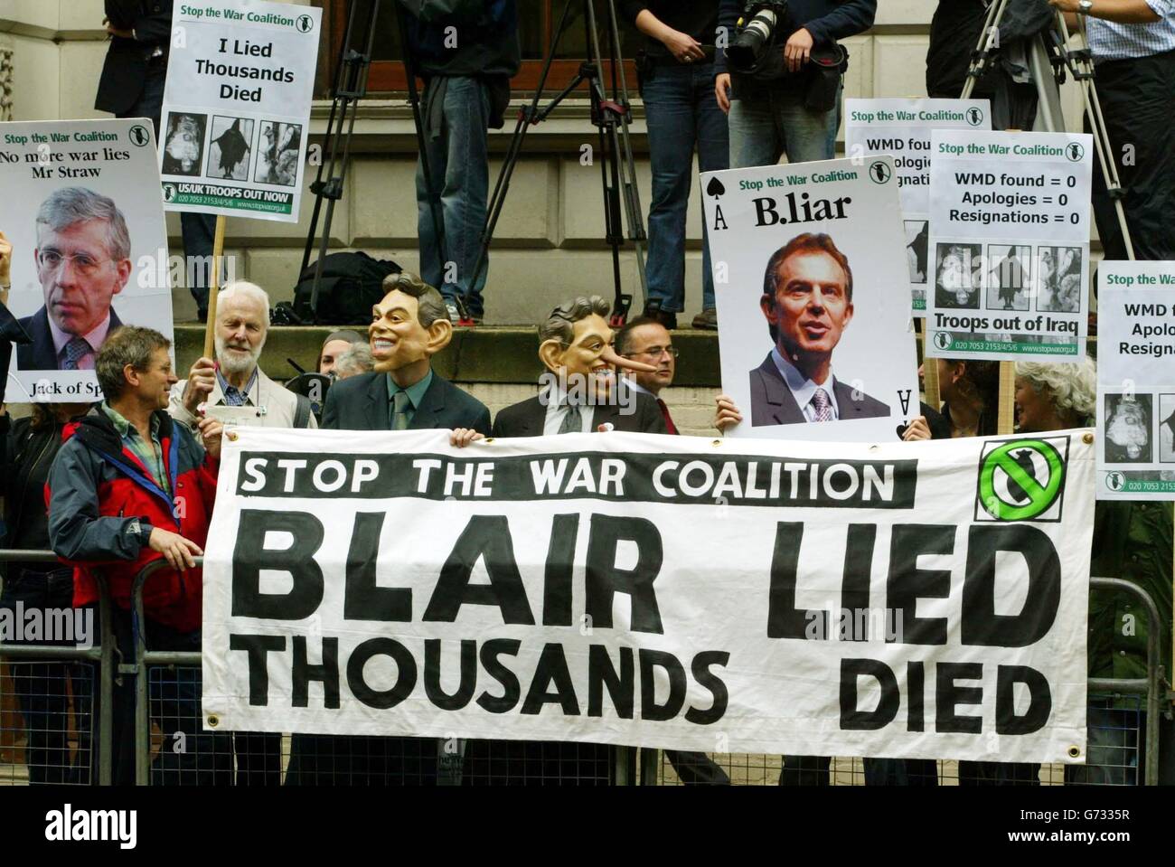 Demonstrators outside a news conference held by Lord Butler in ...