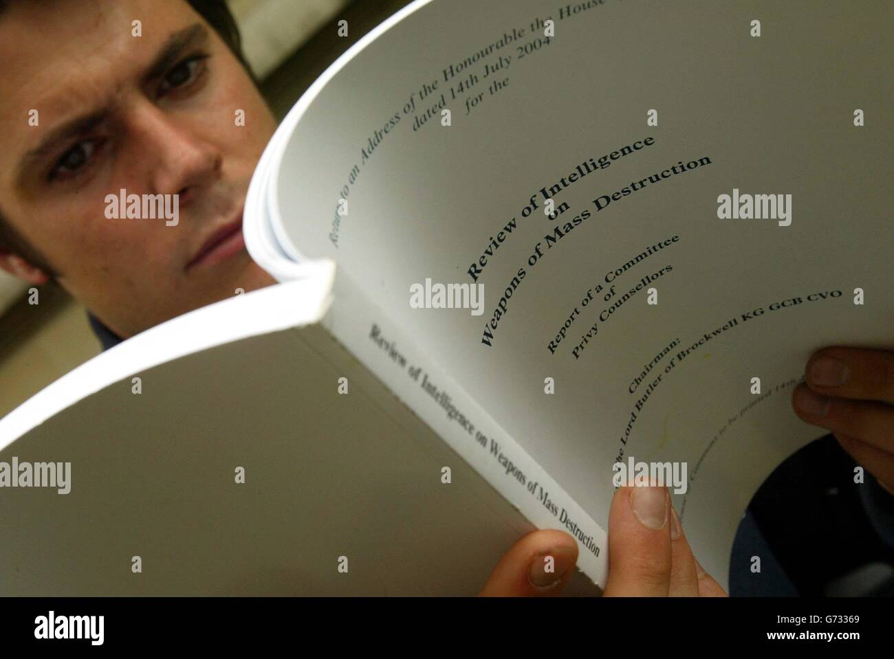 A journalist in Westminster, central London, reads a copy of the report ...