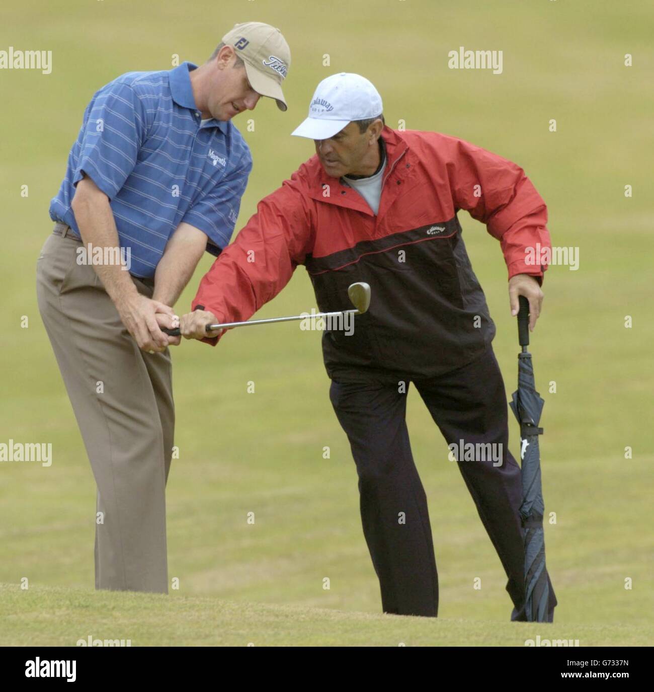 New Zealand's Craig Perks (left) is given some help by former Open ...