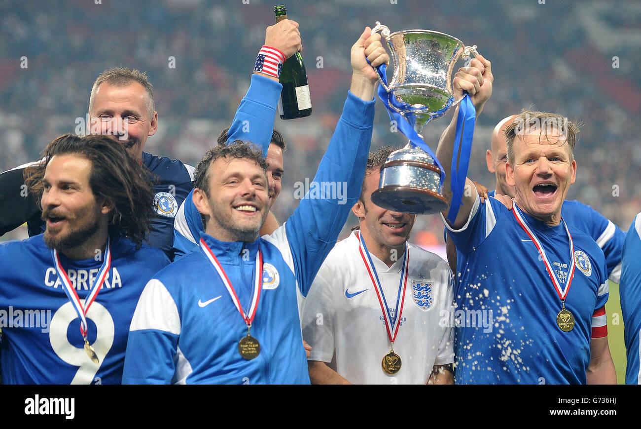 Rest of the World's Michael Sheen and Gordon Ramsay lift the trophy ...