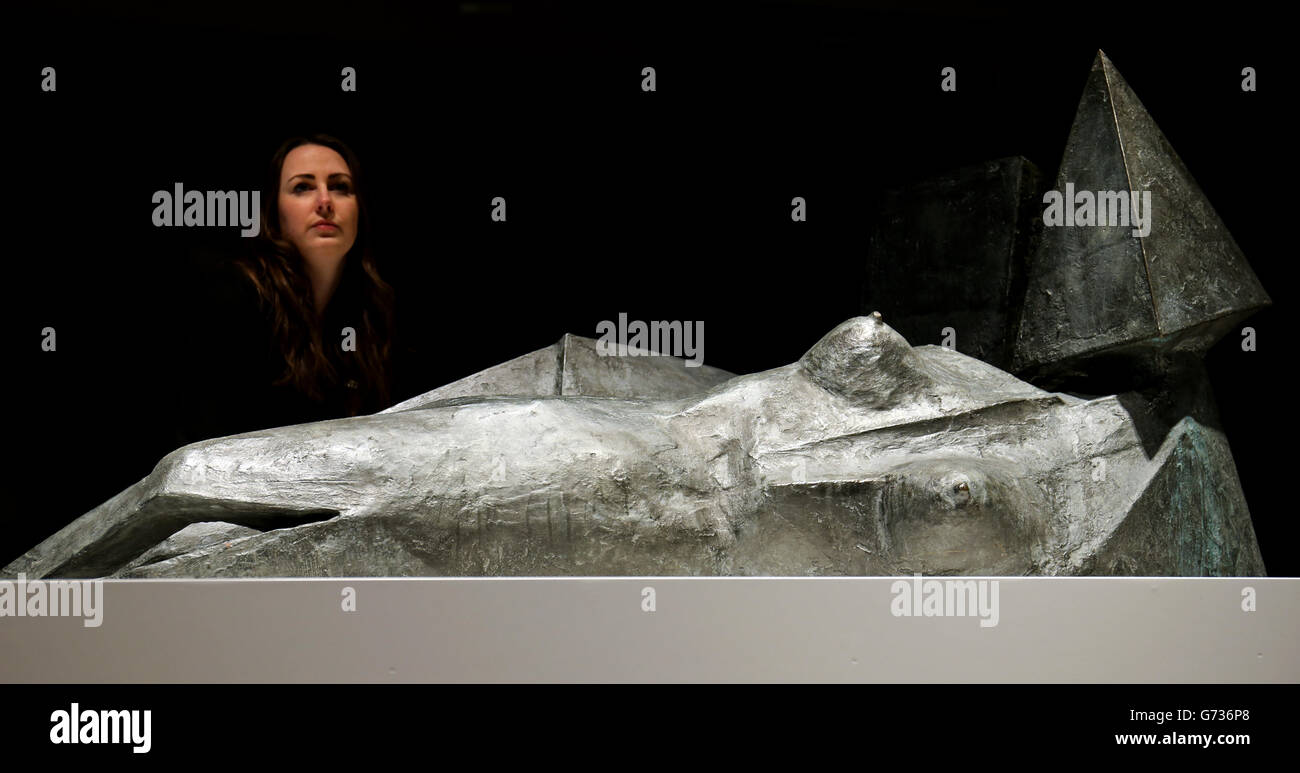 Bonham's staff member Rebecca Holman looks at sculpture Two Reclining ...