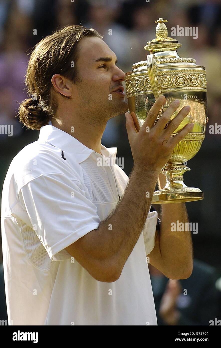 Roger Federer from Switzerland kisses the trophy after defeating Andy ...