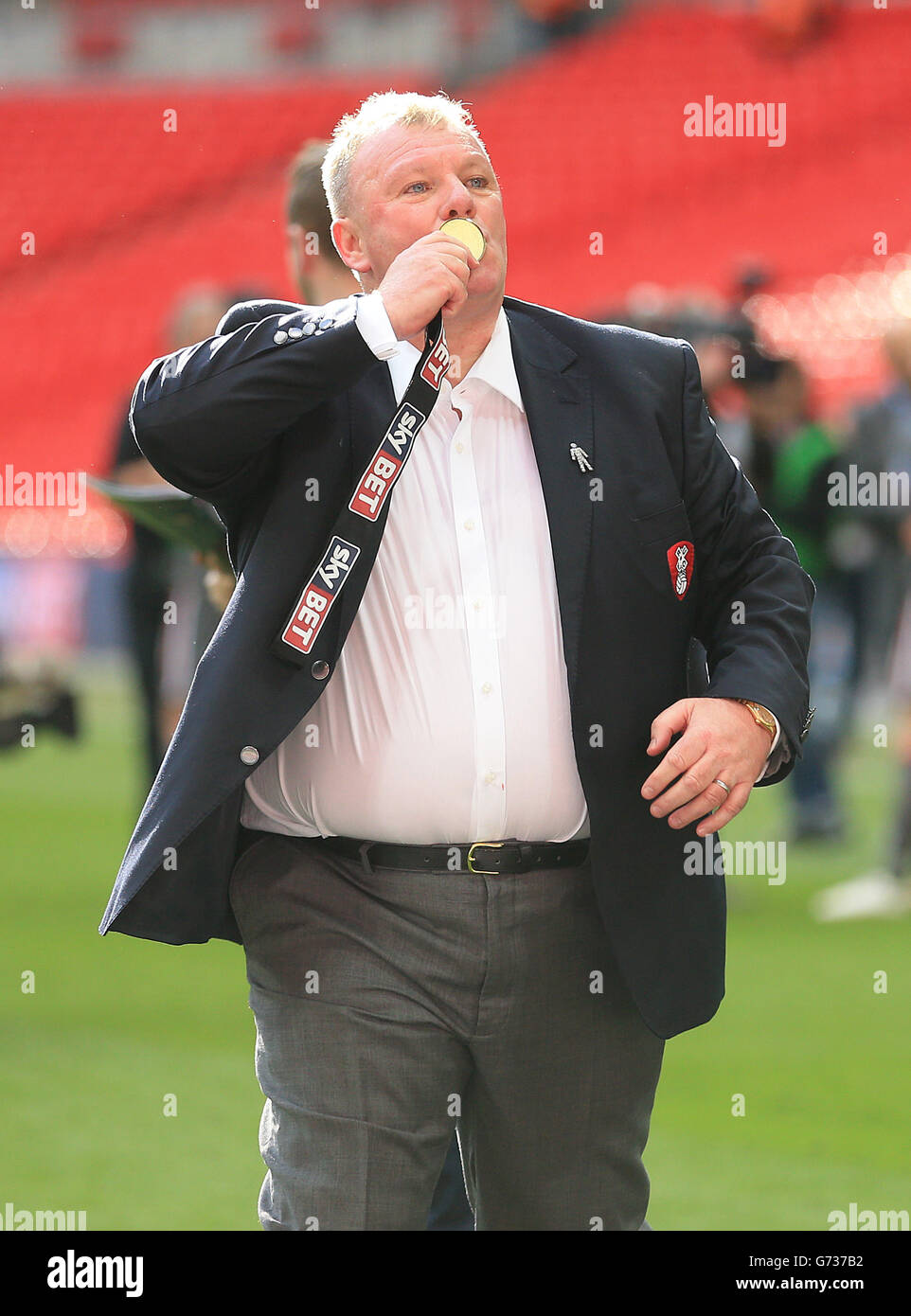 Rotherham United manager Steve Evans celebrates with his winner's medal ...