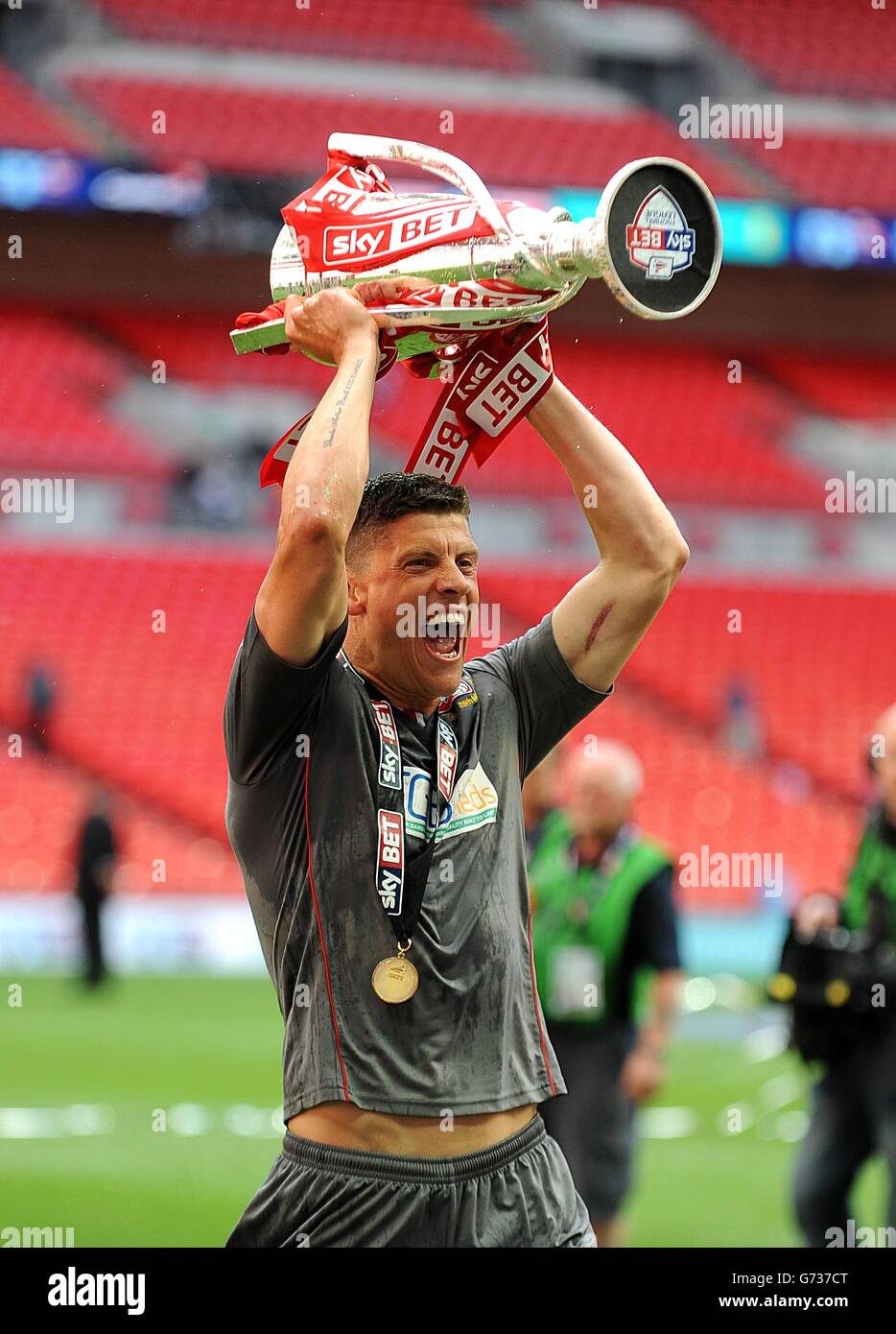 Rotherham United's Alex Revell celebrates victory with the trophy after ...