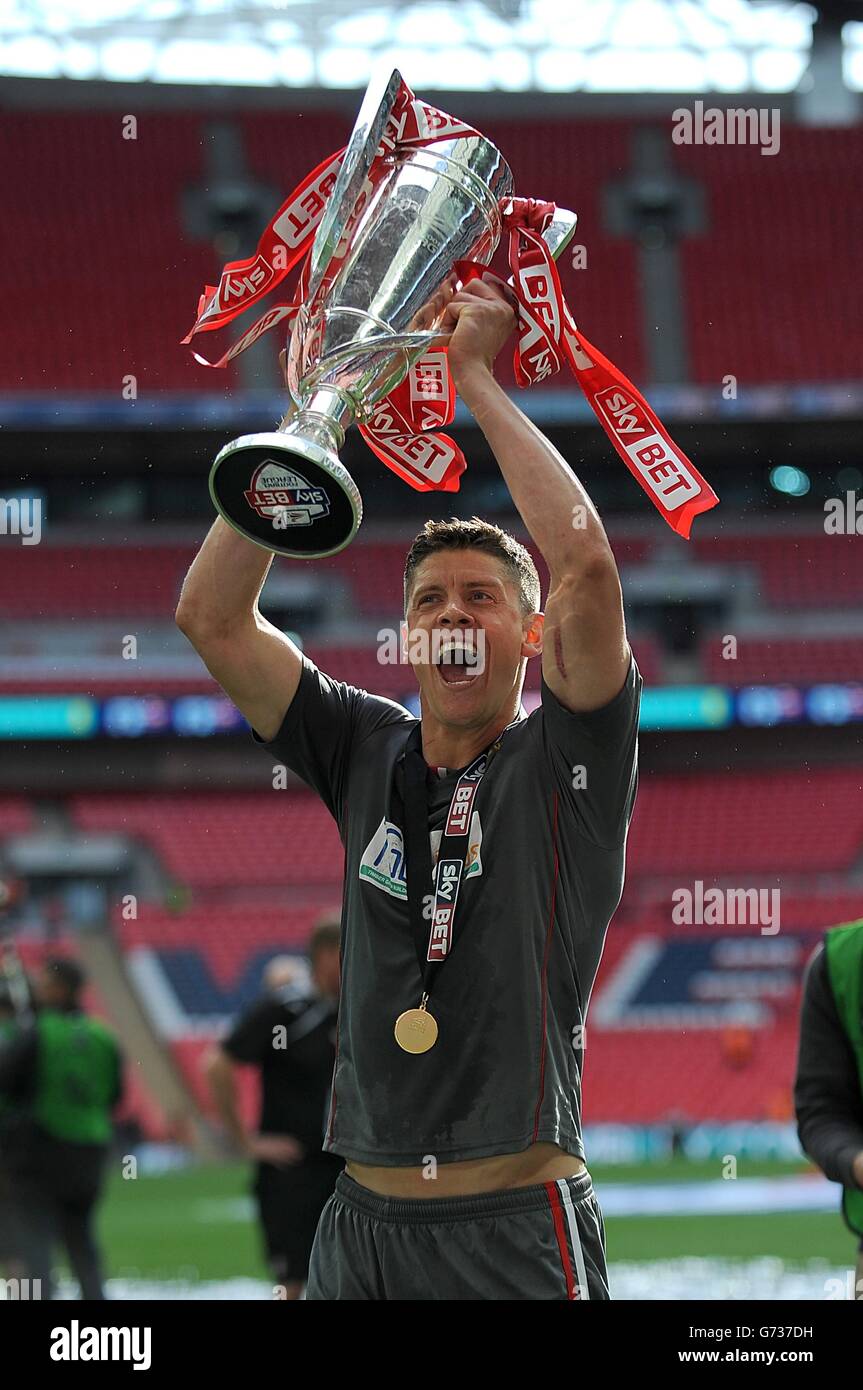 Rotherham United's Alex Revell celebrates victory with the trophy after ...