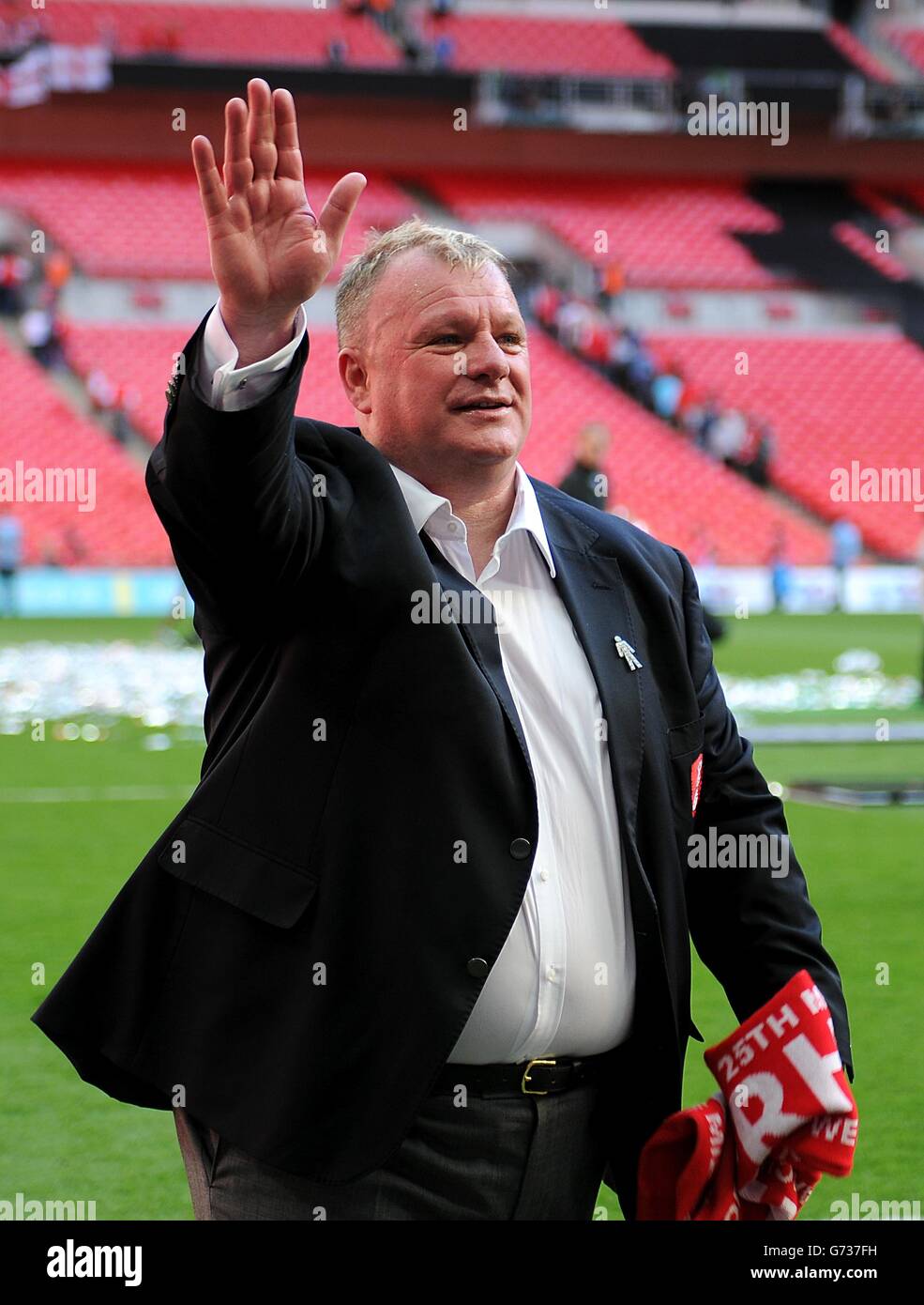 Rotherham United manager Steve Evans celebrates on the pitch after his ...