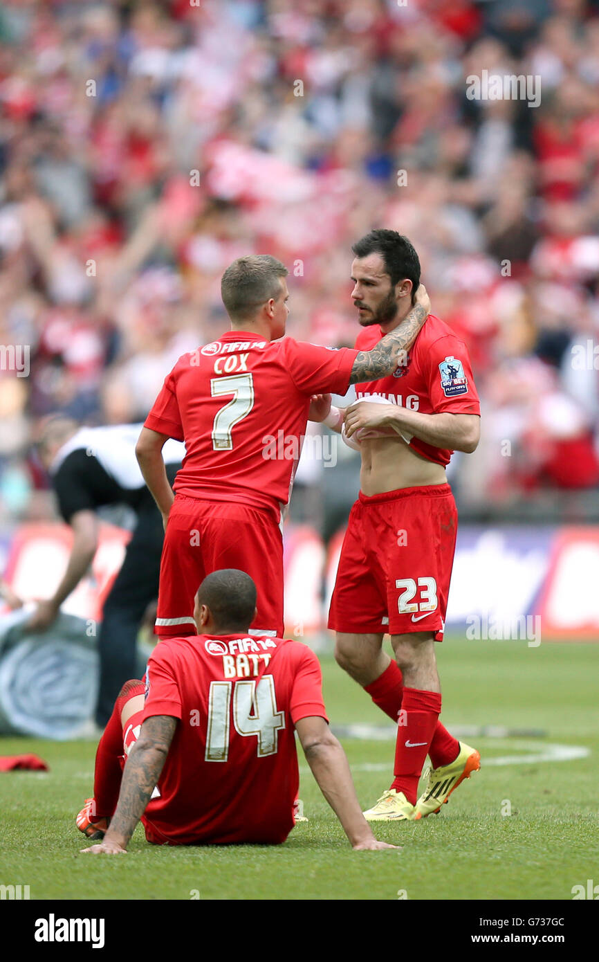Leyton Orient's Chris Dagnall (right) is consoled by team-mate Dean Cox ...