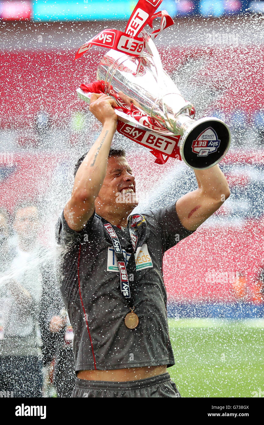 Rotherham United's Alex Revell celebrates promotion with the trophy ...