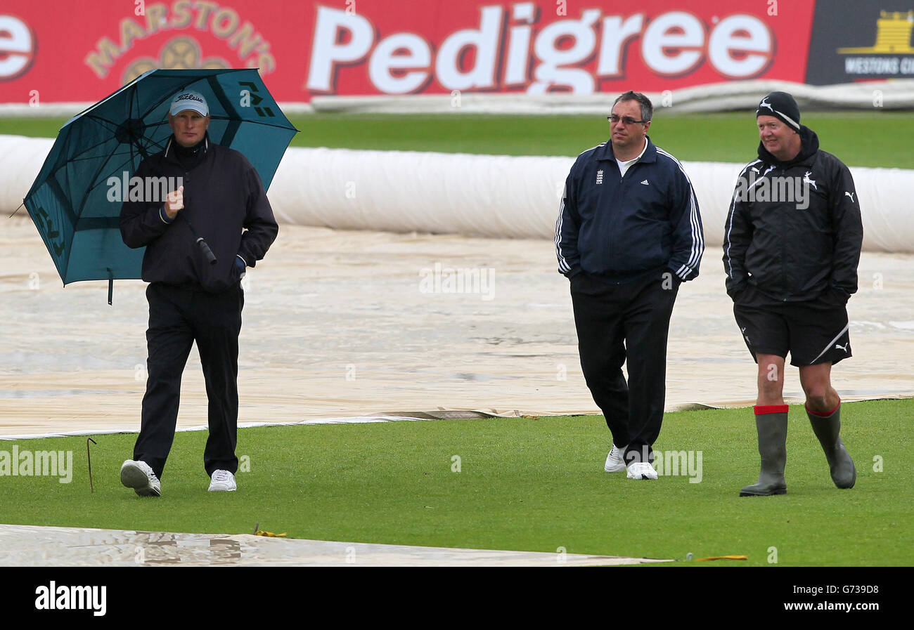 Match umpires Neil Mallender (left) and Neil Bainton (centre) inspect ...