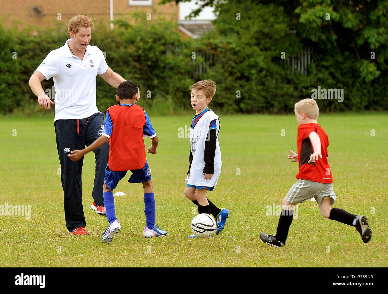 Prince Harry shows off his football prowess, during a kick about with ...