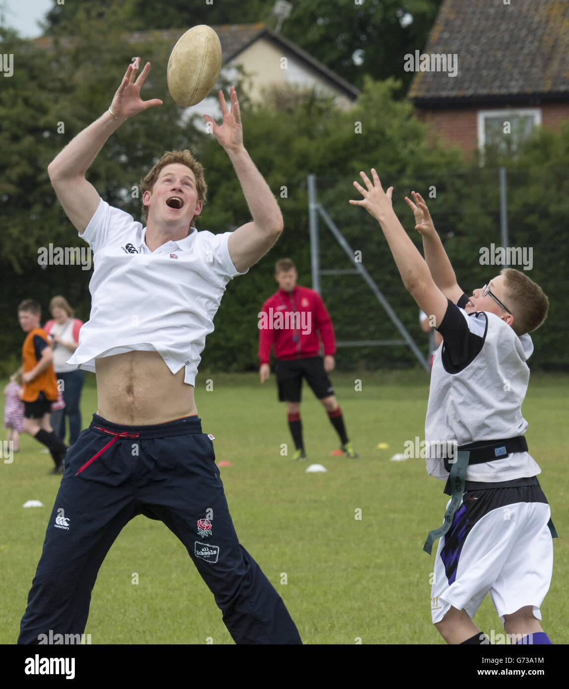 Prince Harry enjoys a game of touch Rugby with young children at the ...