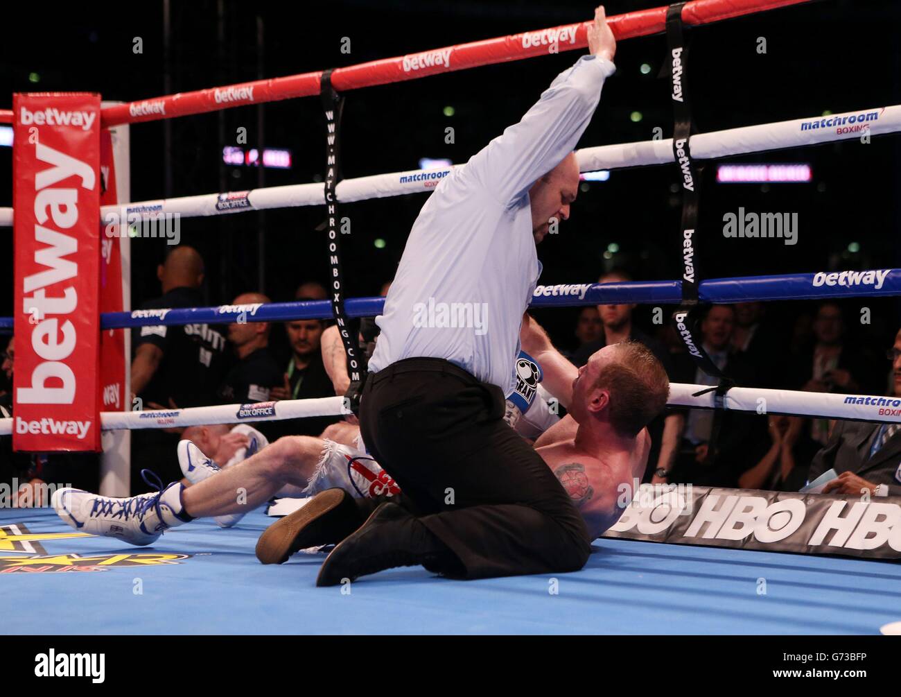 George Groves is counted out by the referee after being knocked down by ...