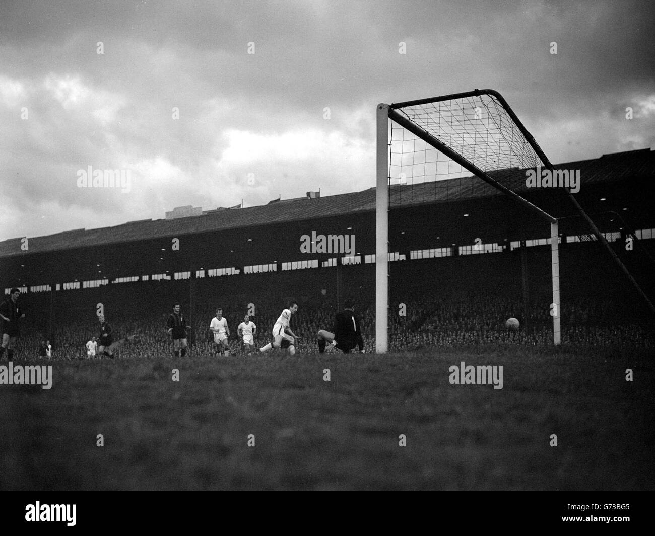 Dennis Viollet sends the ball past the crouching Milan keeper Buffon ...