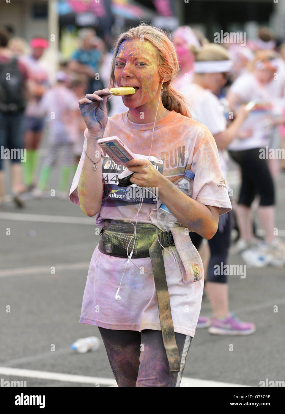 A runner takes part in The Color Run in Wembley, London, a 5k run where ...