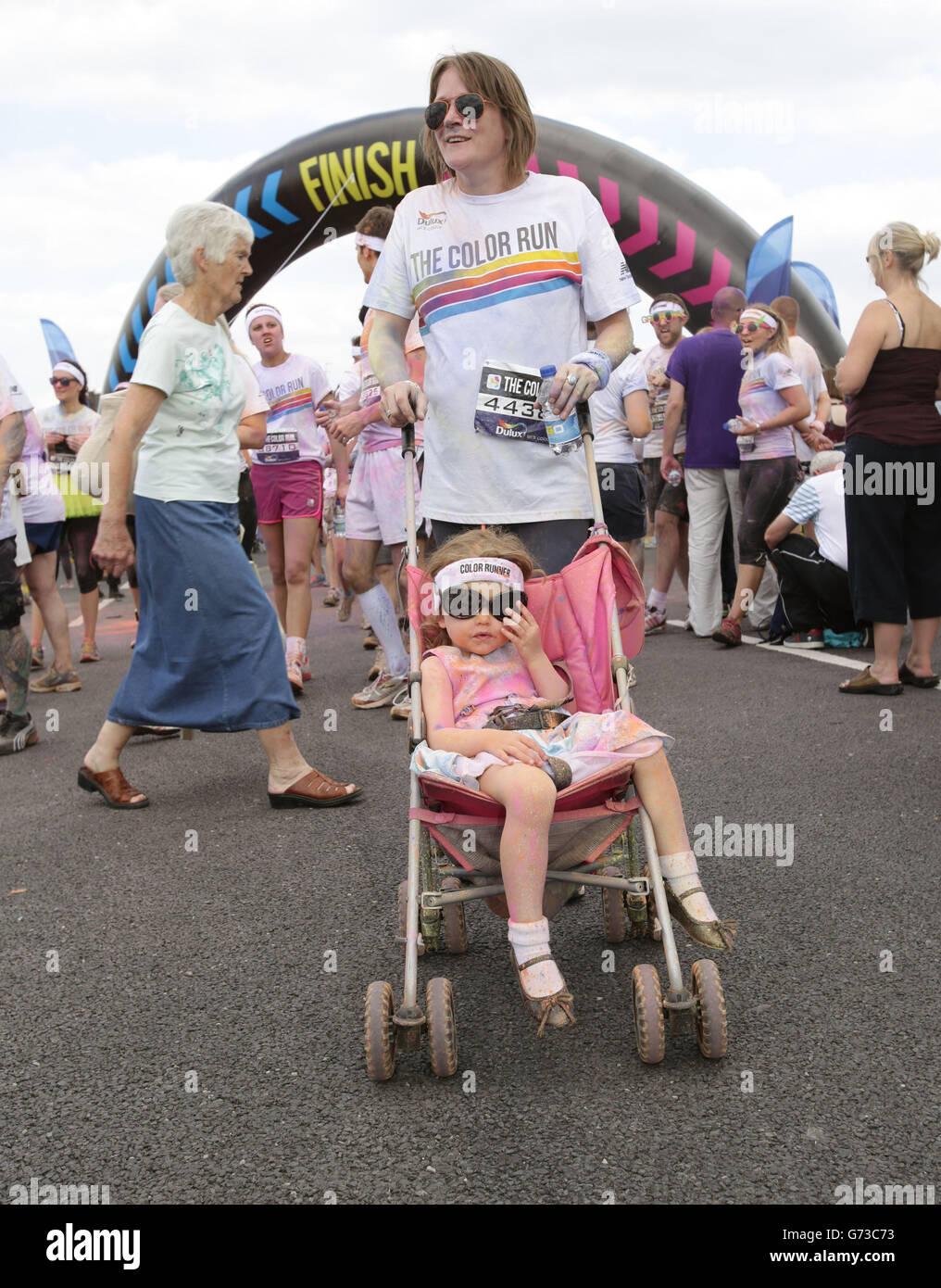 Runners cross the finish line at The Color Run in Wembley, London, a 5k ...