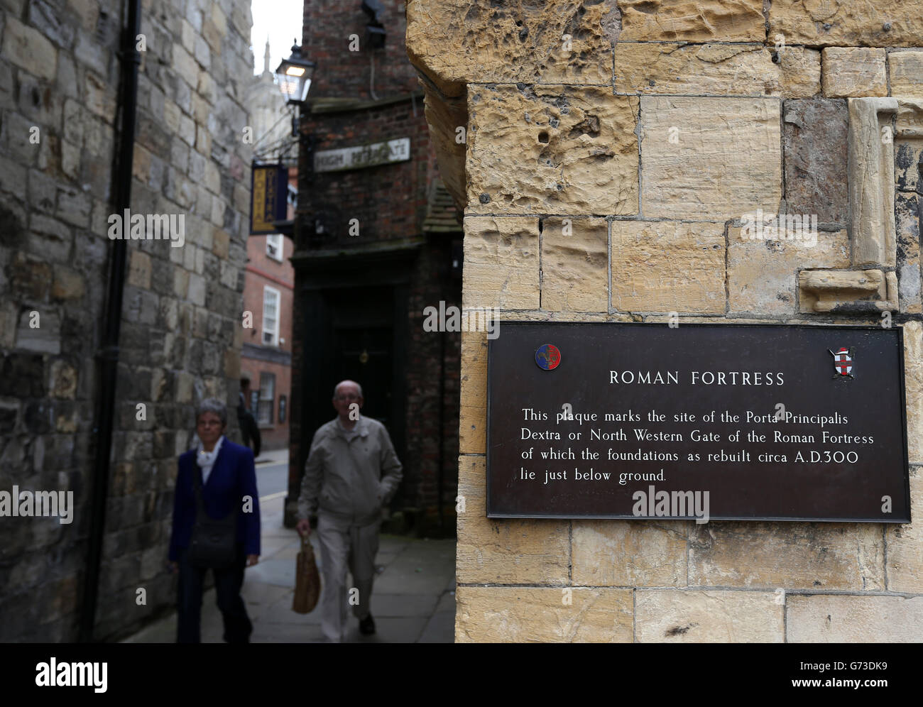 People walk past the walls of a Roman fortress , York Stock Photo - Alamy