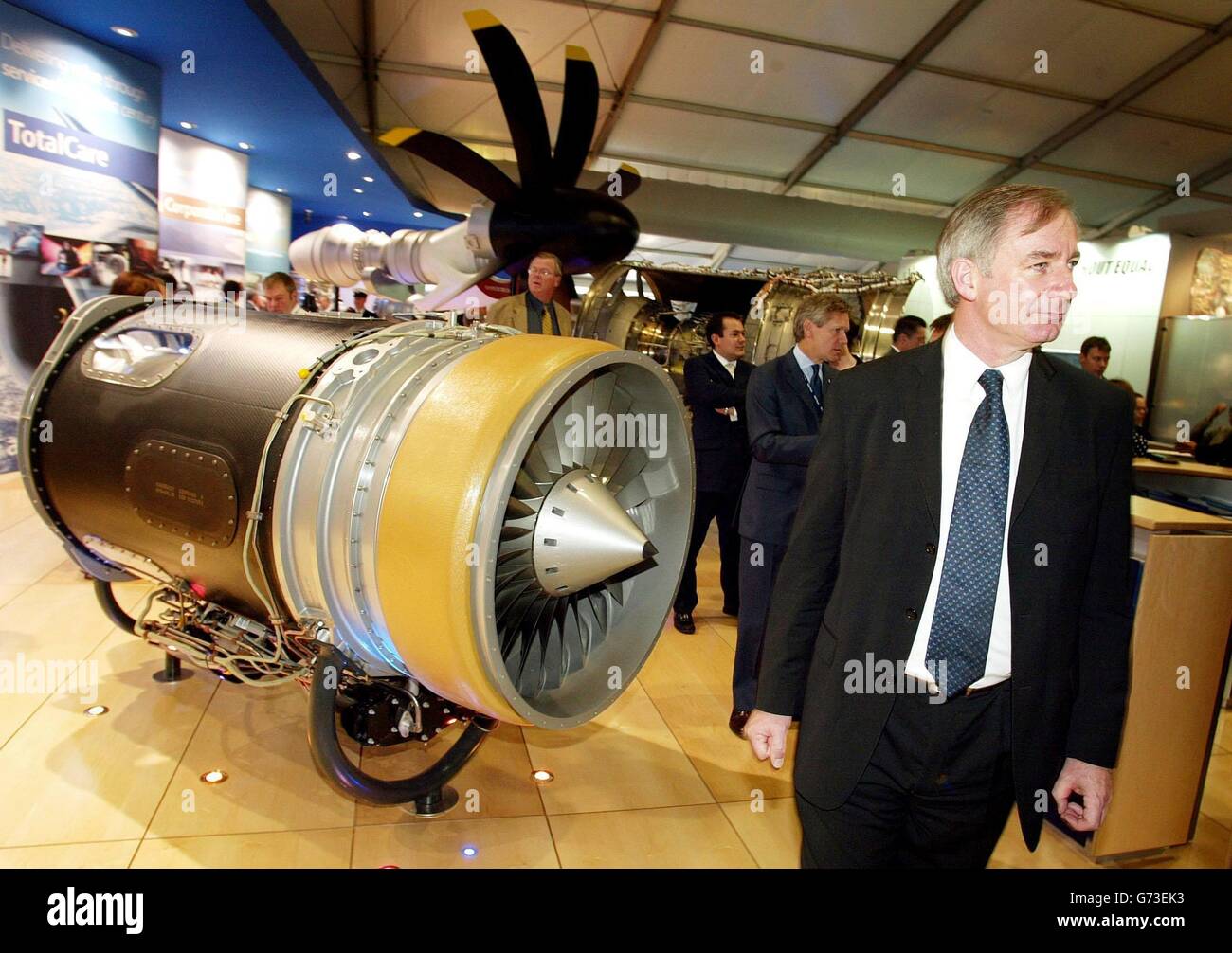Defence Secretary Geoff Hoon stands next to jet engines on the Rolls ...