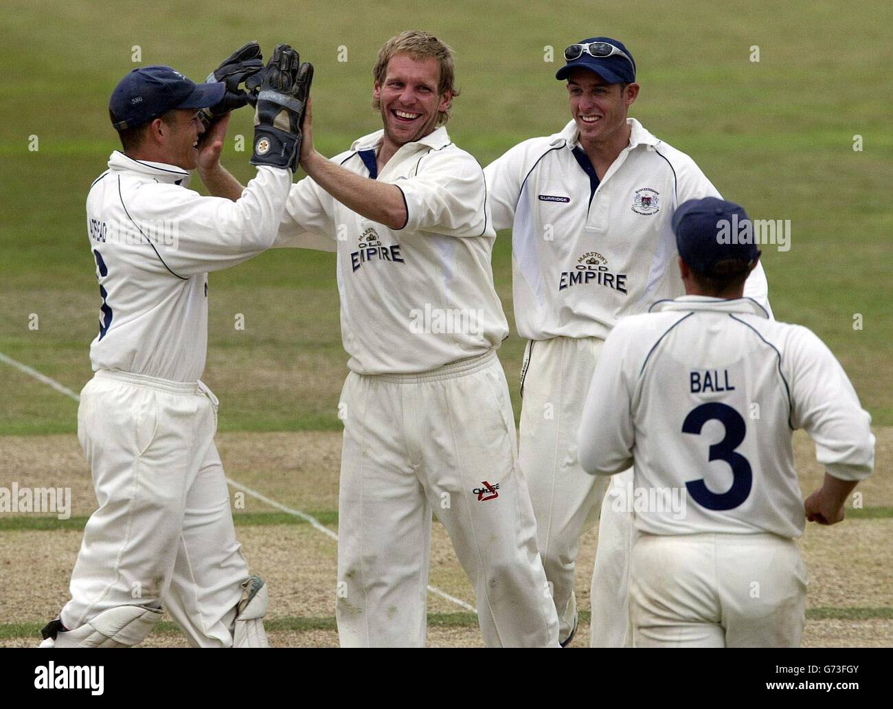 Gloucestershire bowler Ian Fisher (centre) celebrates taking the wicket ...