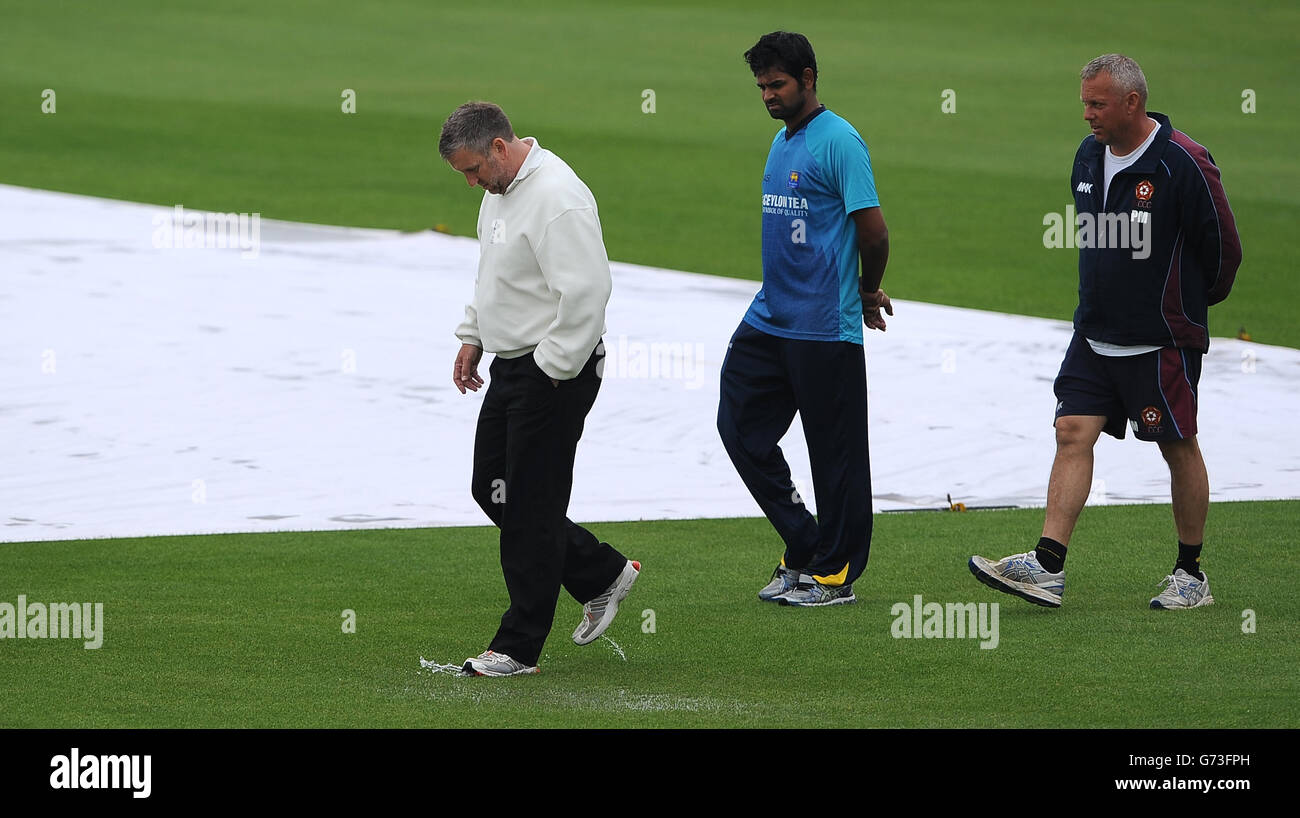 Umpire Paul Pollard (left) inspects the pitch alongside Sri Lanka's ...
